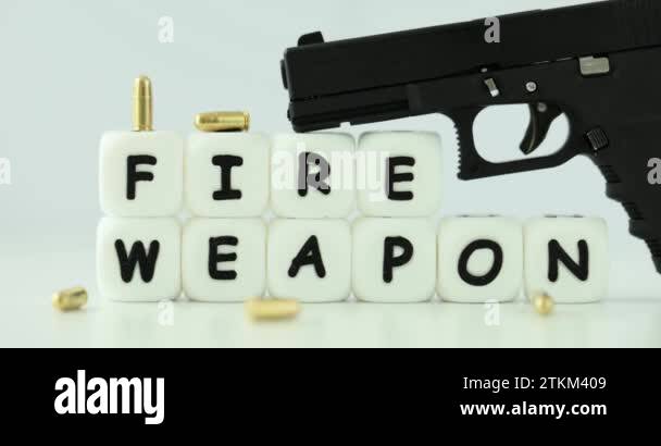 Automatic handgun with golden bullets against phrase Fire Weapon made ...