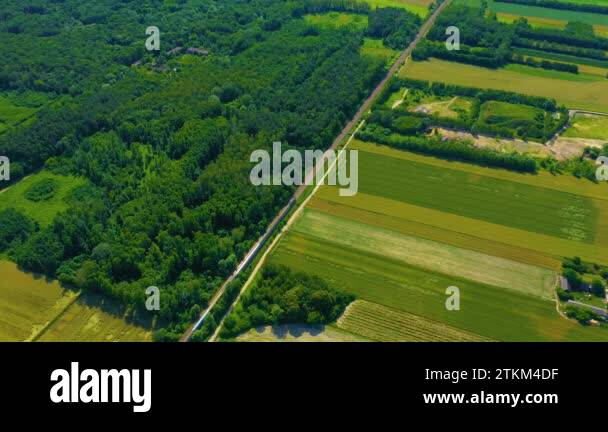 High-speed train of red color moving diagonally aerial view. Train ...
