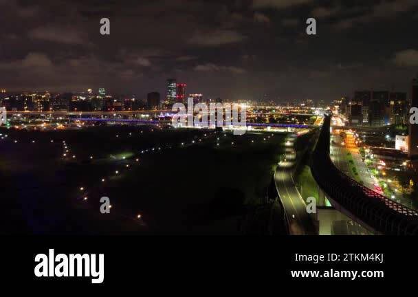 Aerial 4k video of Xinbei Bridge at night. Cars pass through the bridge ...
