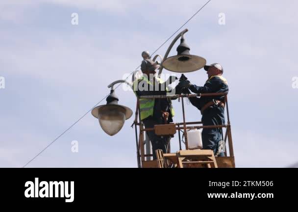 lift bucket, replace light bulb, during installation. Worker repairing ...