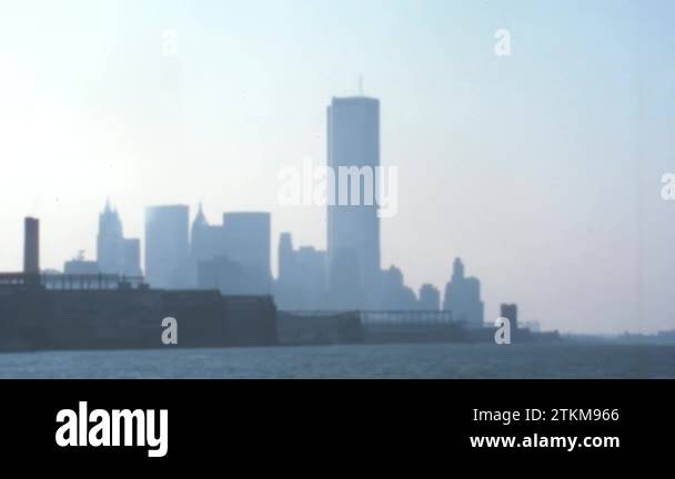 New York Manhattan skyline silhouettes against the sun with iconic ...