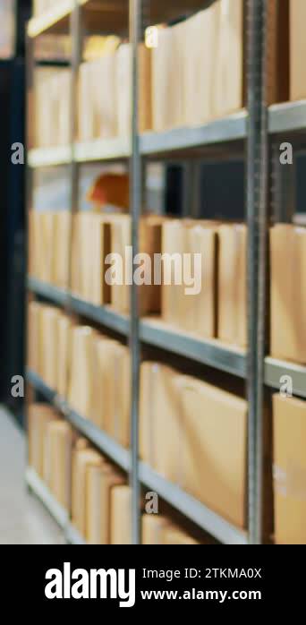 Vertical video: Empty storage room with packages on depot racks ...