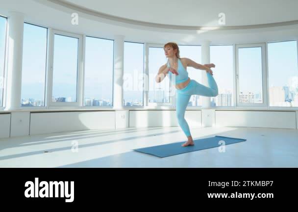Fit Adult Woman Practicing Yoga Sequences Of Dancer Pose And Standing