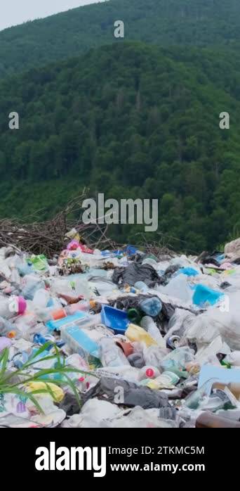 A landfill in the middle of beautiful mountains and forest. Landfill of ...