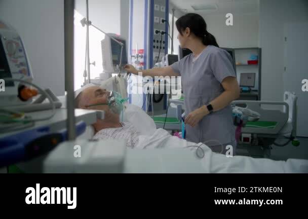 Emergency room with modern equipment in clinic. Senior man in oxygen ...