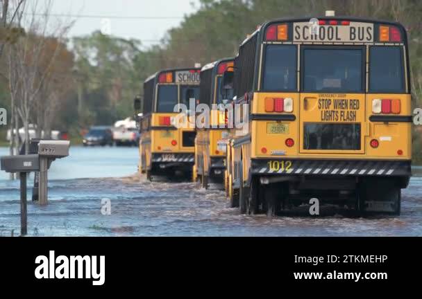 Hurricane Ian flooded street with moving evacuation school buses in ...