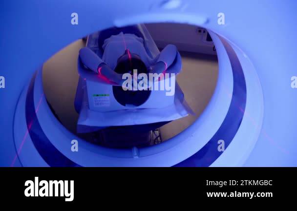 4k video girl patient lies on computed tomography bed and scanning ...