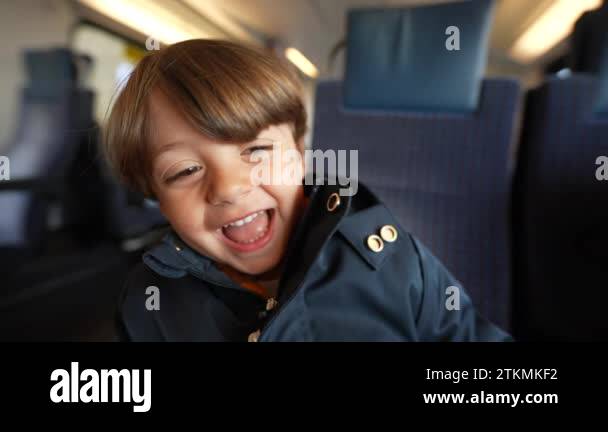 Happy child laughing and smiling while traveling by train. Portrait ...