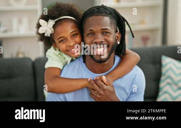 African American Father And Daughter Smiling Confident Hugging Each