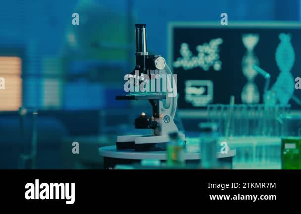 Microscope, glass test tubes and flasks on the background of a computer ...