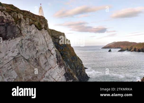A rocky coastline marked by its rugged, steep terrain and occasional ...