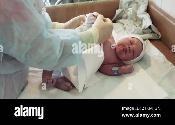 Nurse put on disposable diaper on newborn crying baby in diapers after ...