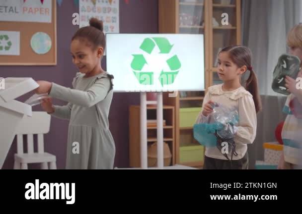 Diverse first grade pipuls and their teacher taking part in eco project ...