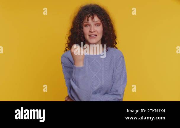 Aggressive angry curly haired woman trying to fight at camera, shaking ...