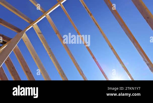 Building new house using wooden frames installing truss structures for roofs installing new ...