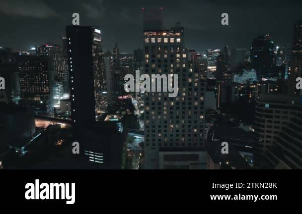 Drone flying at night city with skyscrapers. Urban skyline captured by ...