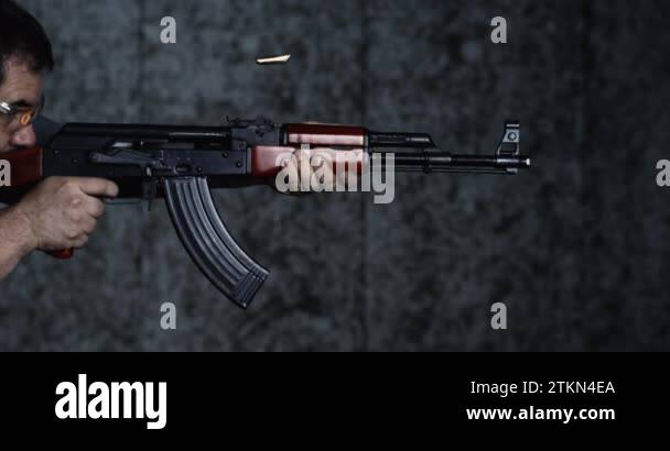 Side view of person shooting an AK-47 Rifle in high-speed 800 fps. Slow ...