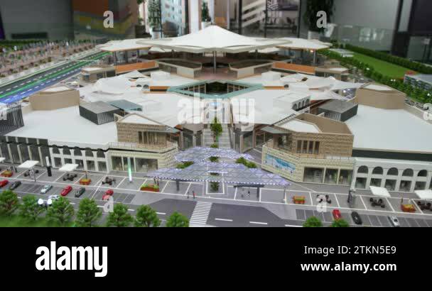 Moving miniature model of a shopping mall with landscape, roads and ...