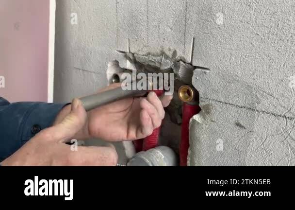Plumbing work on installing the outlet of cold and hot water from the ...