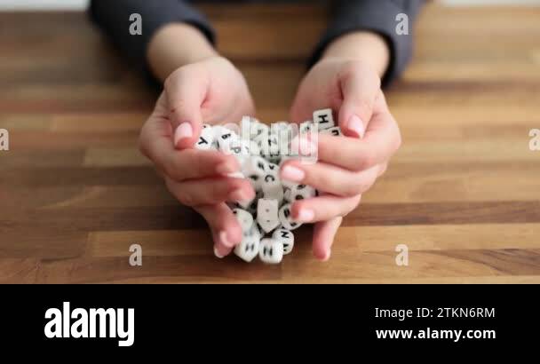 Female hands pouring out cubes with english alphabet closeup 4k movie ...