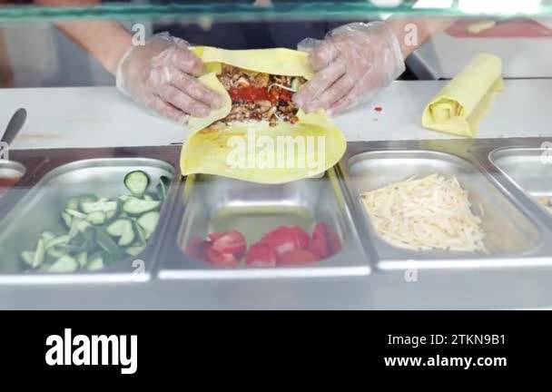 Chef prepares and prepares traditional Turkish doner kebab. Shawarma or ...