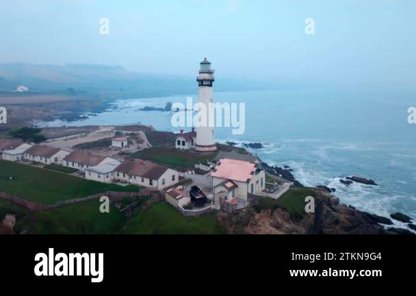 Lighthouse on the ocean shore in rainy coastal weather. High quality 4k ...