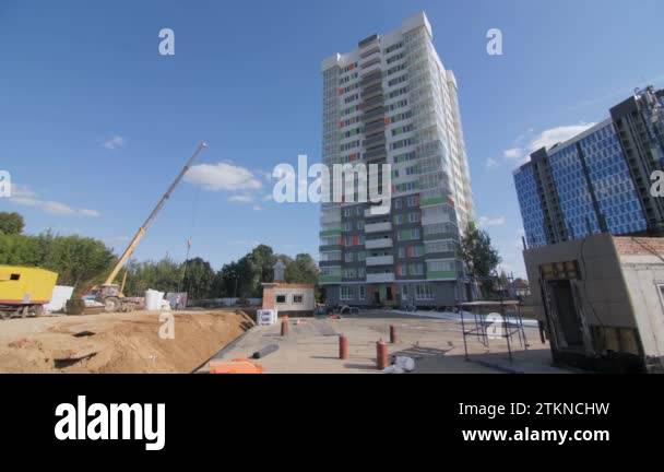Contemporary apartment building and truck crane at construction site ...