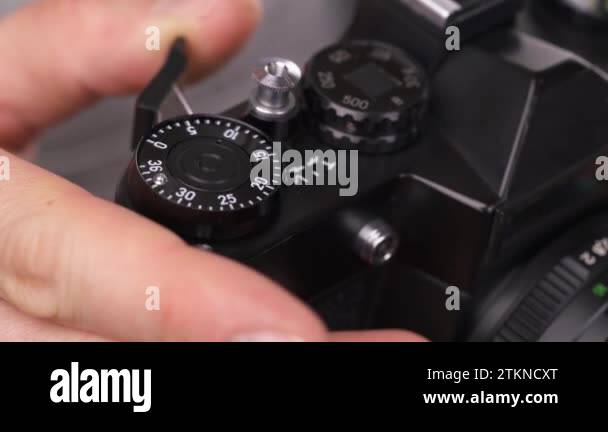 An expert photographer taking pictures using old technology single-lens ...