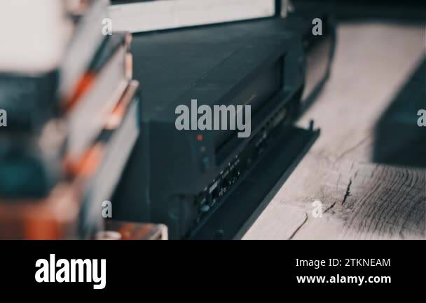 Insert VHS cassette into VCR player. Black vintage videotape cassette ...