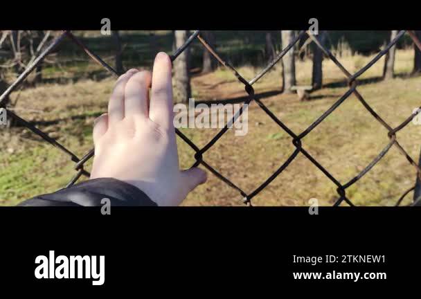 iron grate. steel mesh. the hand is holding the grate. a man's hand ...