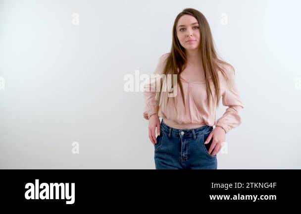 slow motion video of beautiful girl in jeans, hands in pockets on a ...