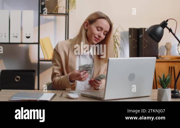 Rich businesswoman working on laptop pc counting money cash, calculate ...