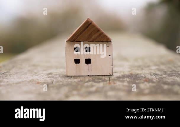 Earthquake concept. Shaking wooden house model close up Stock Video ...