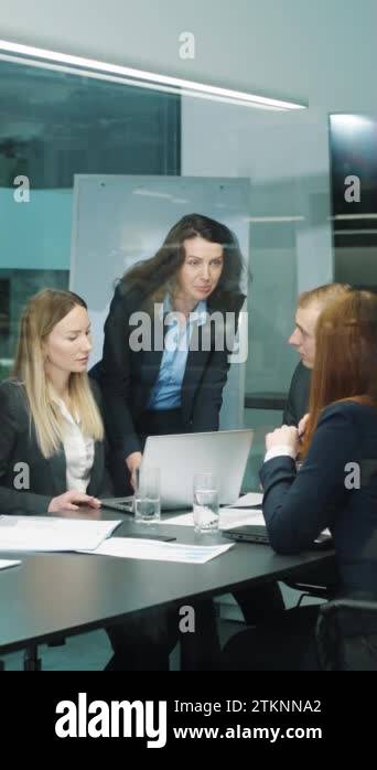 Vertical: Business people wearing official wear gathering together in ...