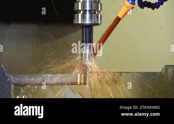 The CNC milling machine rough cutting the mold parts with oil coolant ...