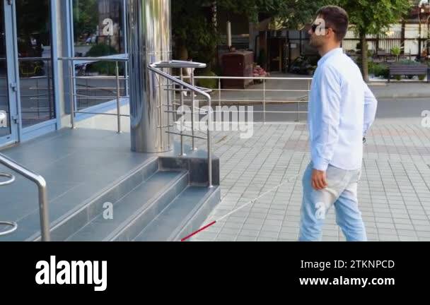 A blind man enters the steps in the building Stock Video Footage - Alamy