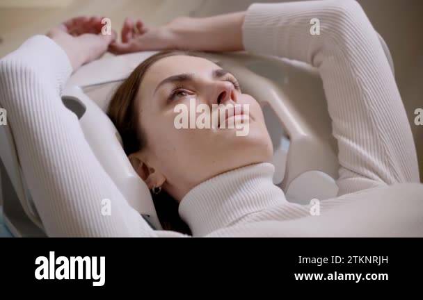4k close-up video CT scan of brains of woman in medical clinic. Girl ...