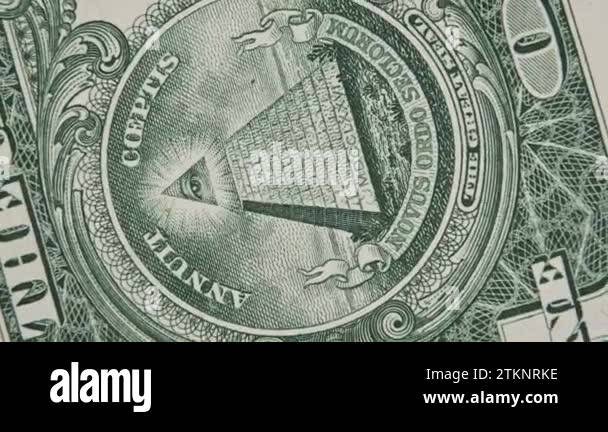 The all-seeing eye sign rotates on a one dollar bill close-up. Mason ...