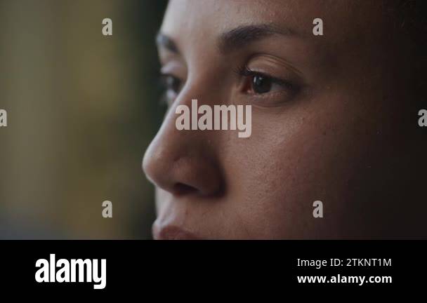 Woman eyes open in slow motion in side view indoors. African American ...