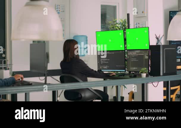 Asian System Engineer Using Html Script Code And Greenscreen On Multiple Monitors In Software