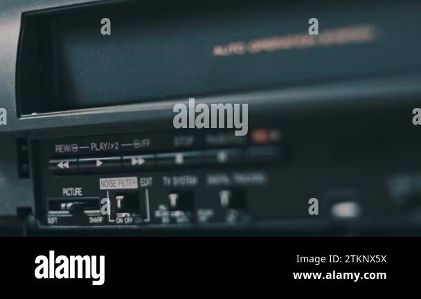 Insert VHS cassette into VCR player. Black vintage videotape cassette ...
