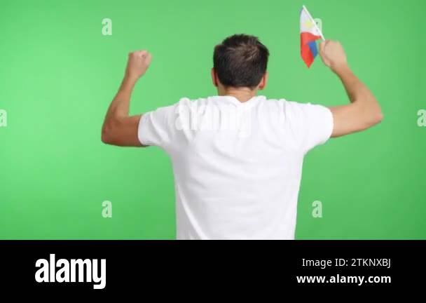 Video in studio with chroma of the rear view of a man waving a ...