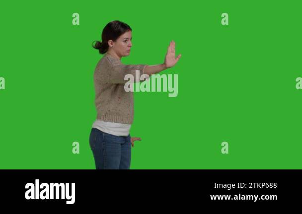 Side view of young woman raising palm as rejection gesture, expressing ...