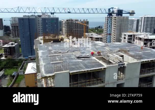 Overview of construction activities on the top stage of a multi-storey ...