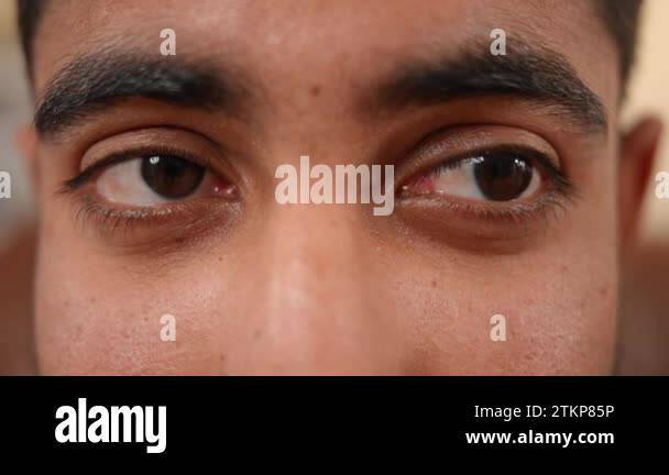 Close-up male Middle Eastern eyes looking side to side looking around ...