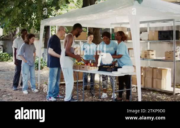 Voluntary individuals assist the less fortunate at a food bank. Meal ...