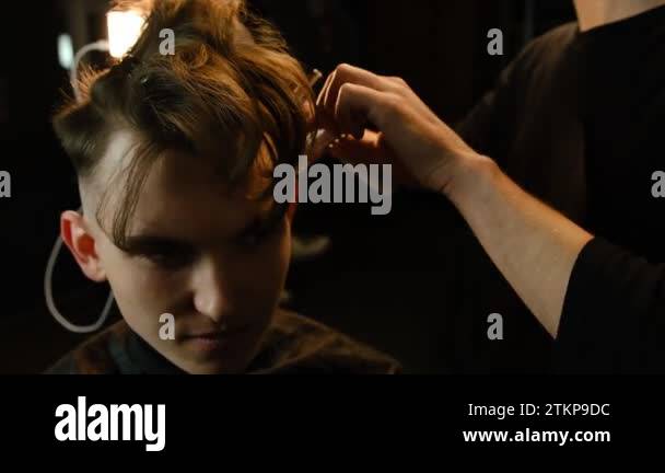 Close up Barber master hairdresser does hairstyle and style with ...