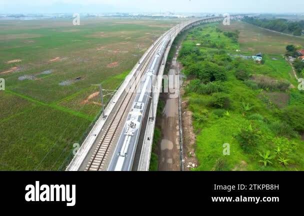 Aerial view of the High speed orange train on the railway station. High Speed Train Jakarta ...