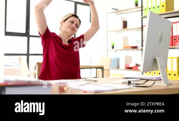 Stress relief woman manager relaxes at workplace and stretches body ...