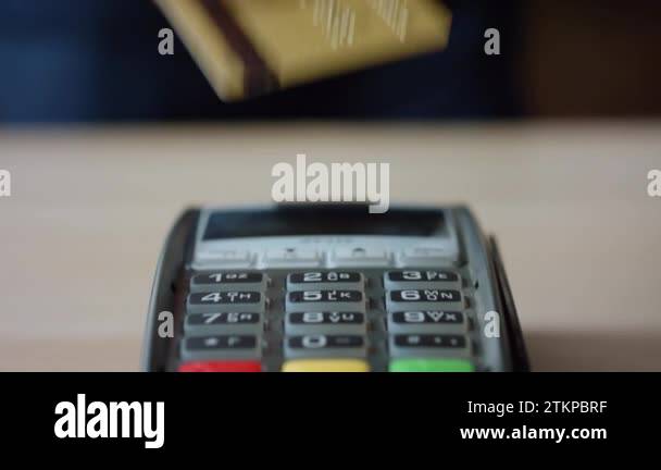 Closeup contactless plastic card transaction on bank wireless terminal ...